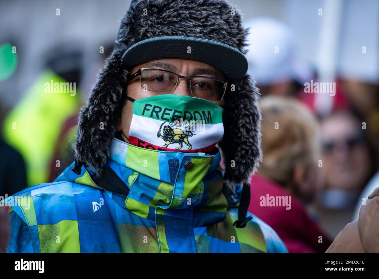 A protestor wears a face mask which states, "Freedom for Iran", during ...