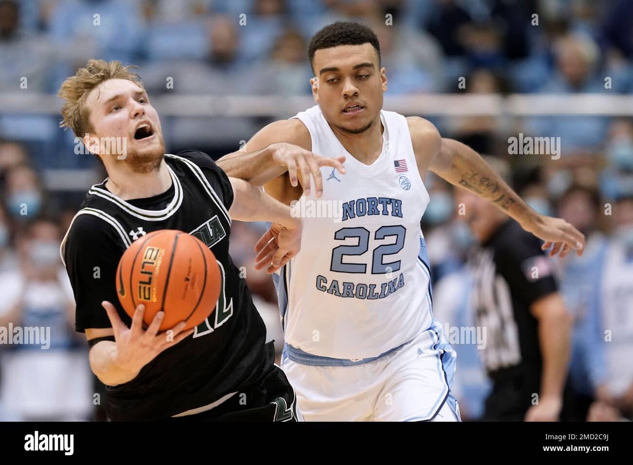 Loyola Maryland guard Cameron Spencer (12) and North Carolina forward ...