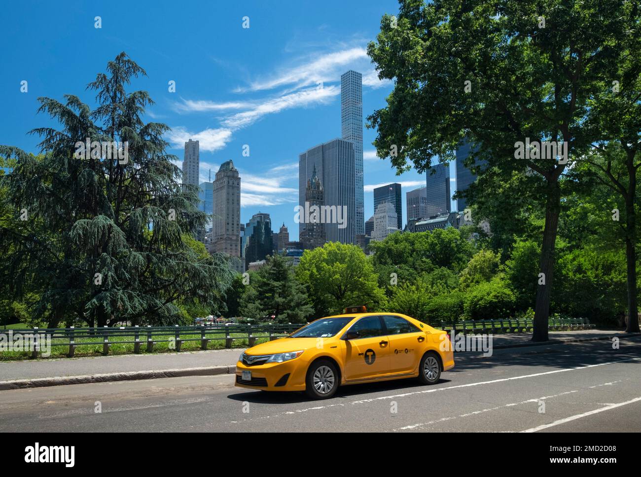 New York Yellow Cab in Central Park with New York City skyline behind ...