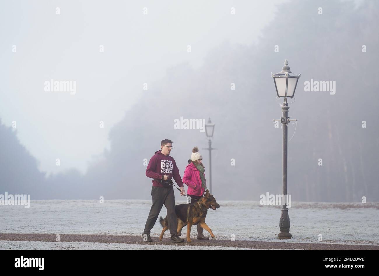 People walk their dog around the Sandringham Estate in Norfolk. A ...