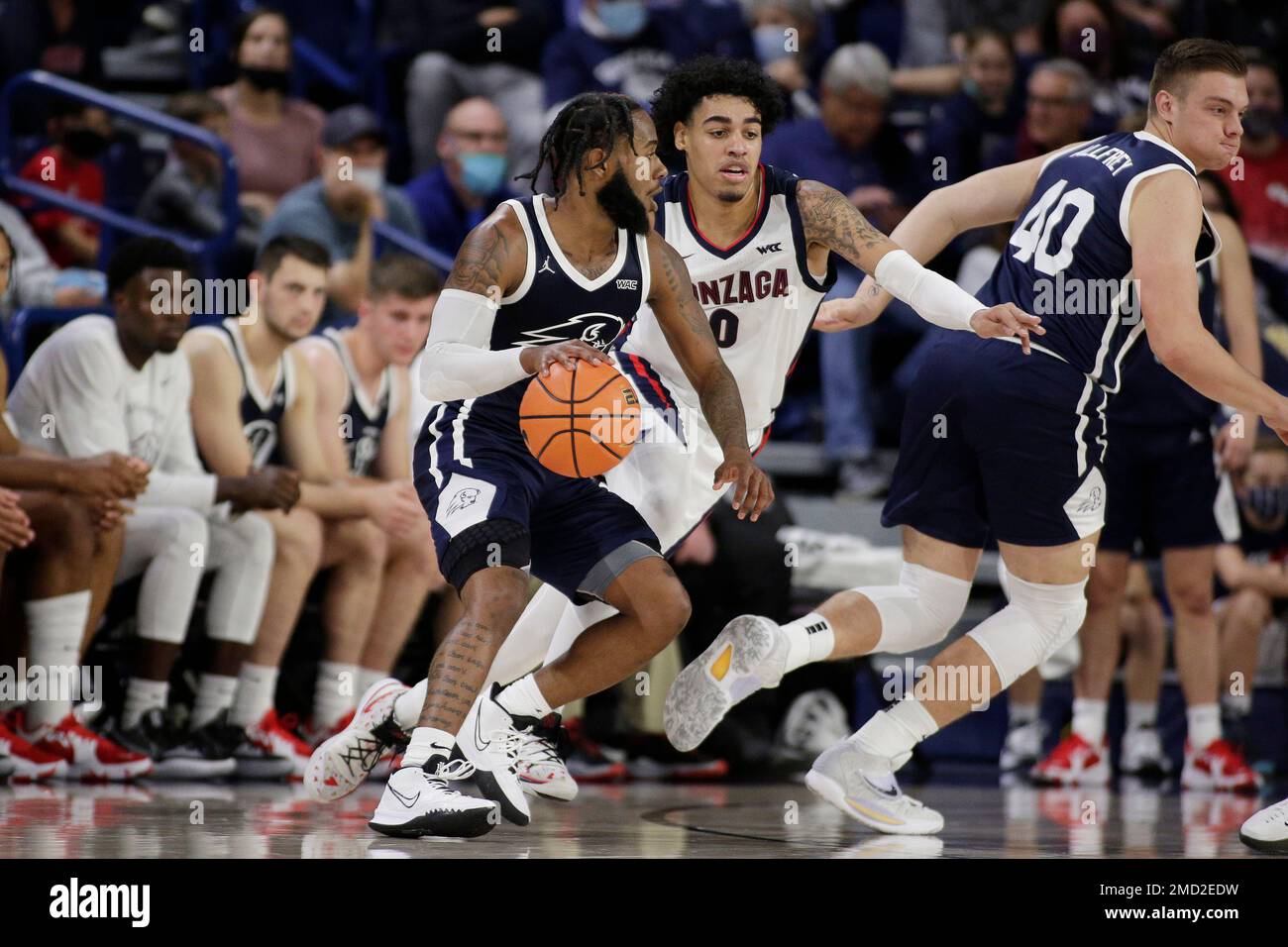 Dixie State guard Cameron Gooden, left, controls the ball while ...