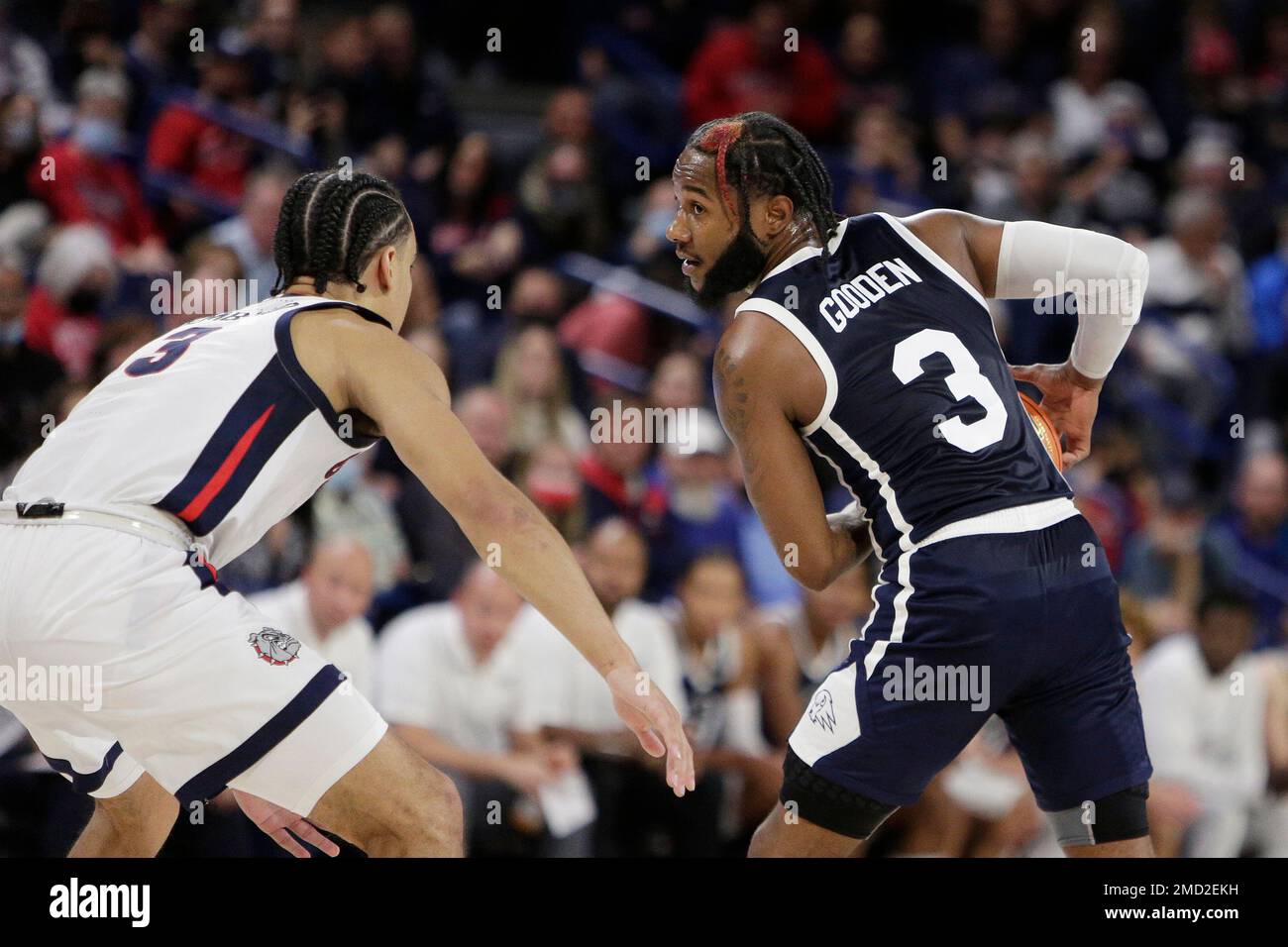 Dixie State guard Cameron Gooden, right, controls the ball while ...