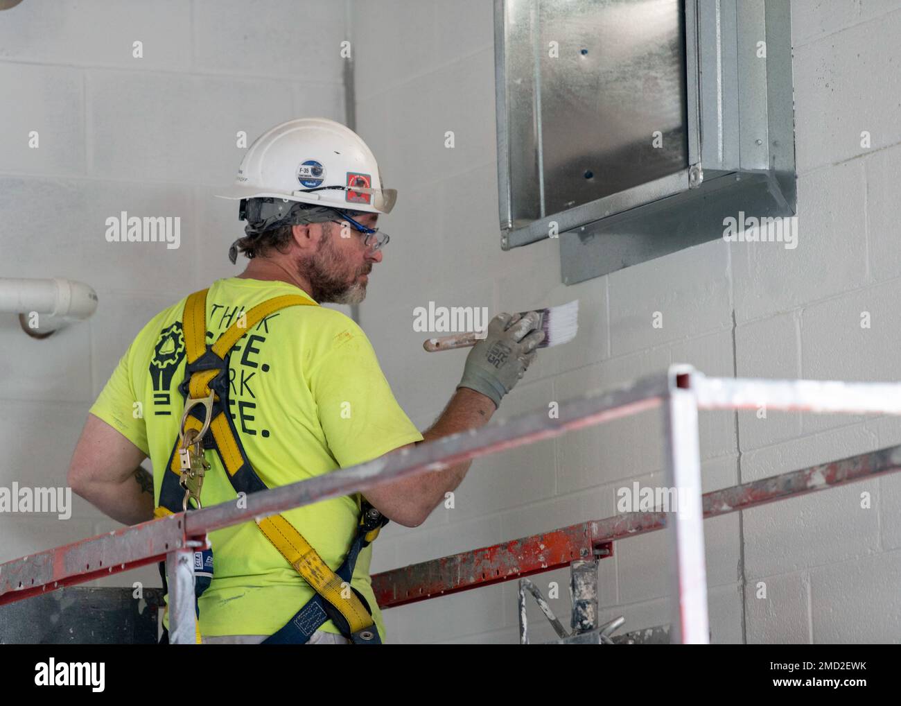 A contractor with local J.H. Findorff & Son Inc. paints a hangar wall ...