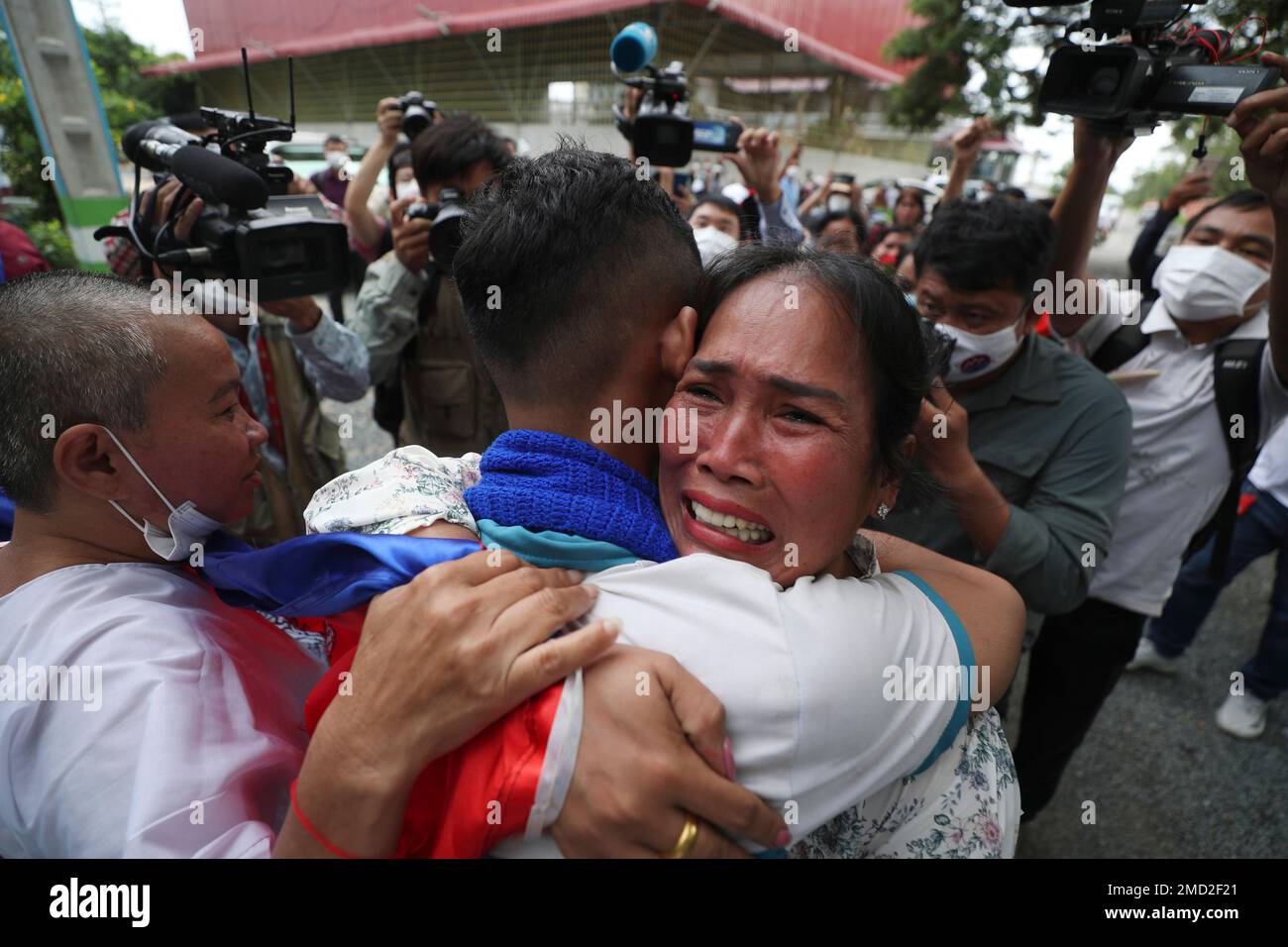 Prum Chantha, front right, hugs her son Kak Sovannchhay, 16, front left ...