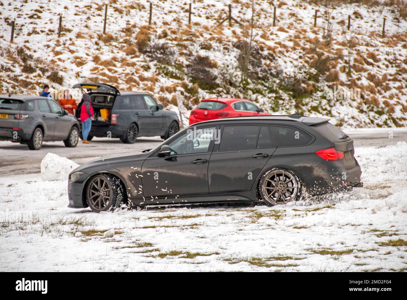 Brecon, UK. 22nd Jan, 2023. A BMW struggles for traction in the snow ...
