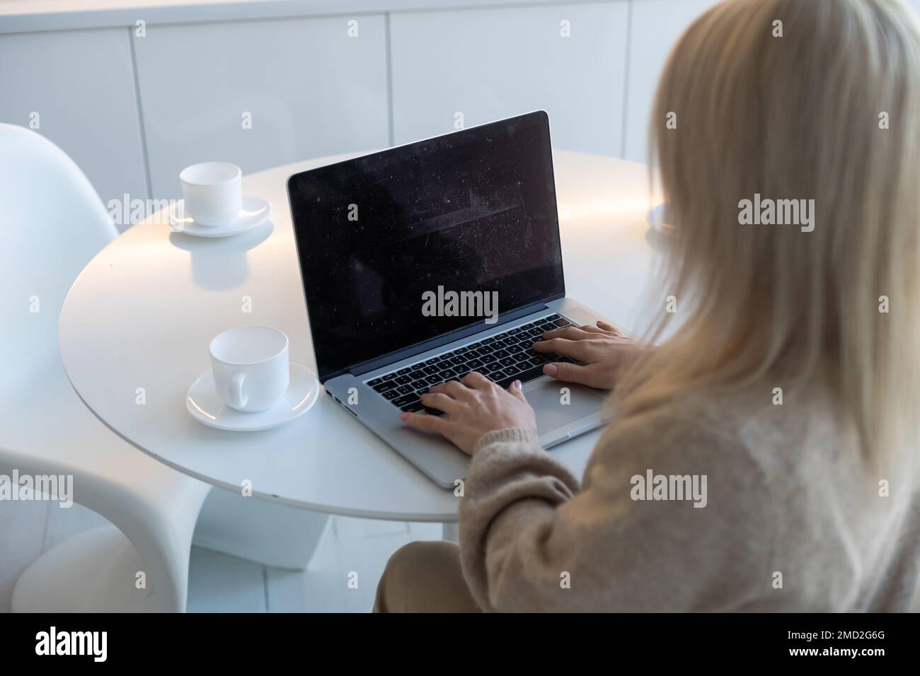 young woman working from home using computer, at home workplace using ...