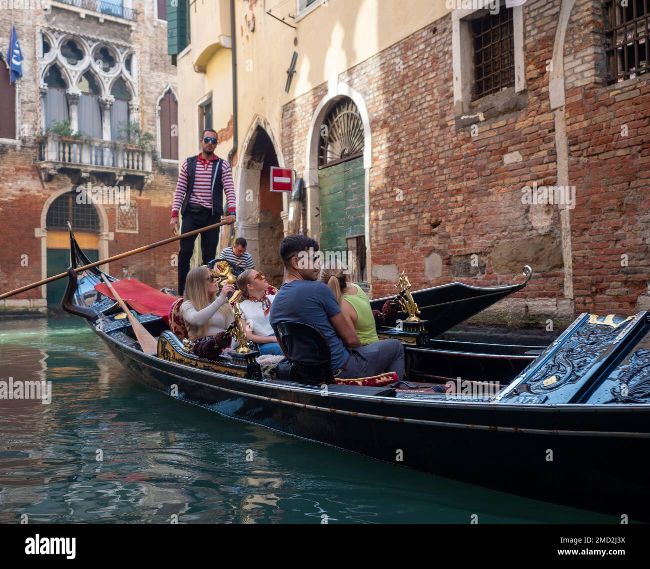 October 31, 2022 - Venice, Italy: Group of tourists taking a gondola ...