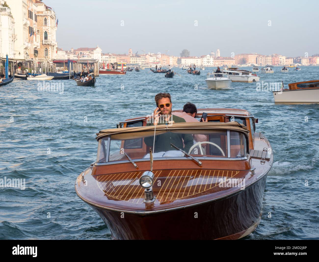 October 31, 2022 - Venice, Italy: Man talking on the phone while ...