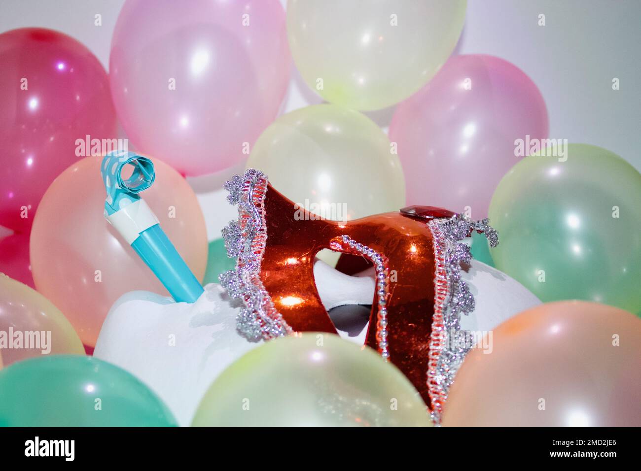 The colorful balloons, party horns and a carnival mask for birthday ...