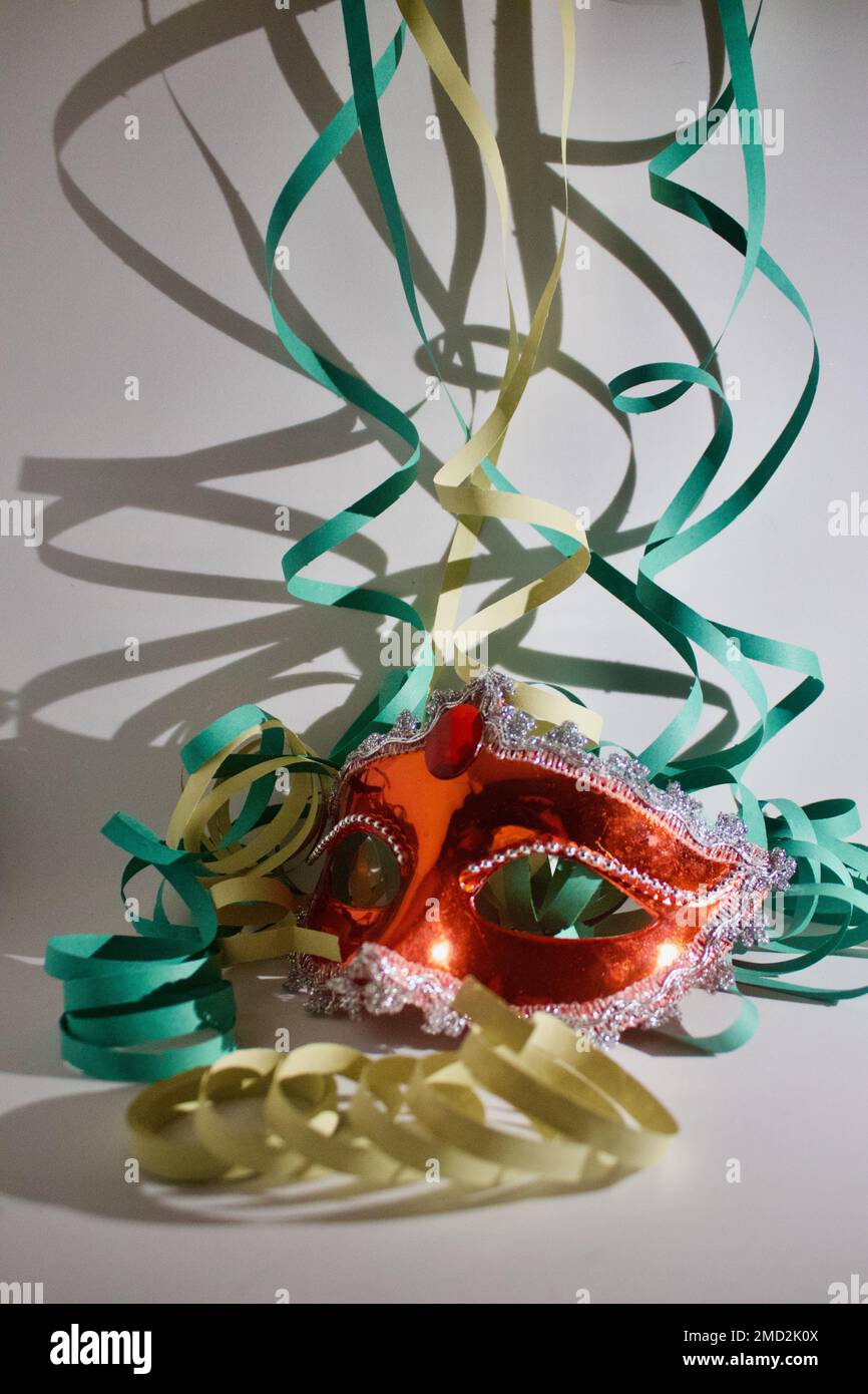The red carnival mask with colorful paper streamers for party ...