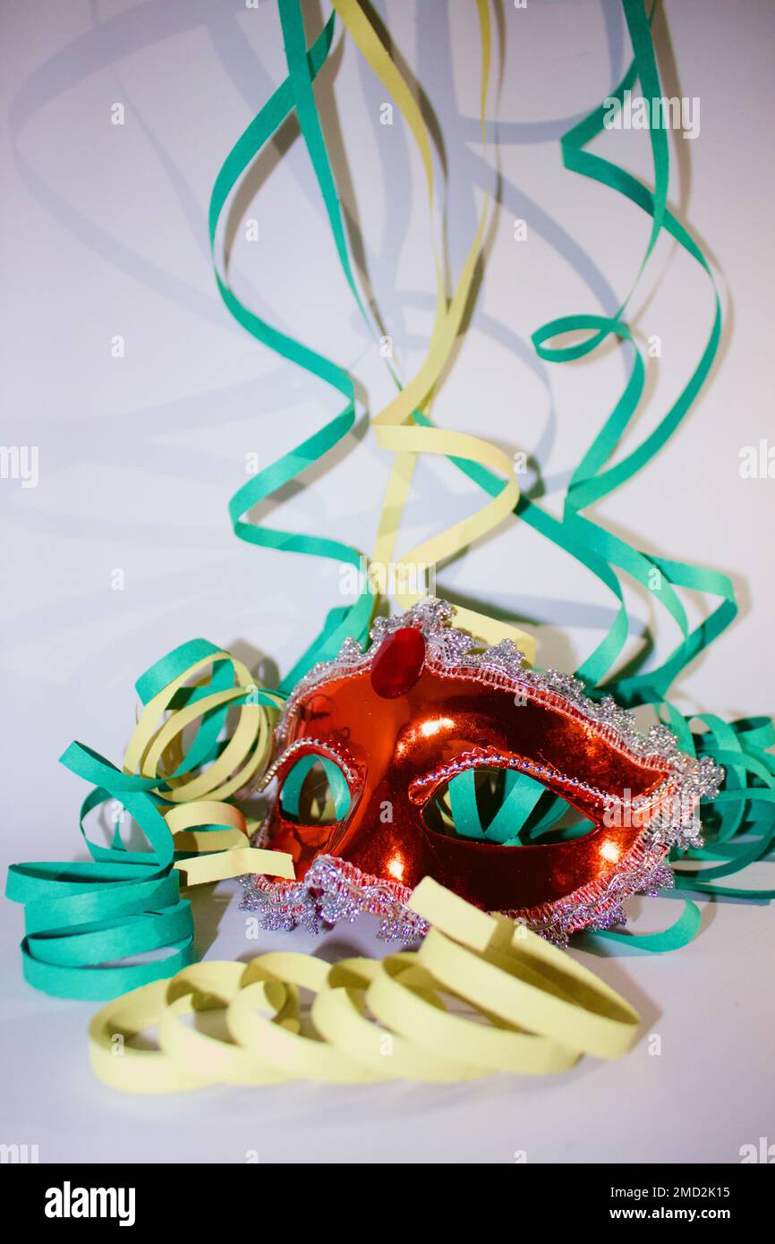 The red carnival mask with colorful paper streamers for party ...