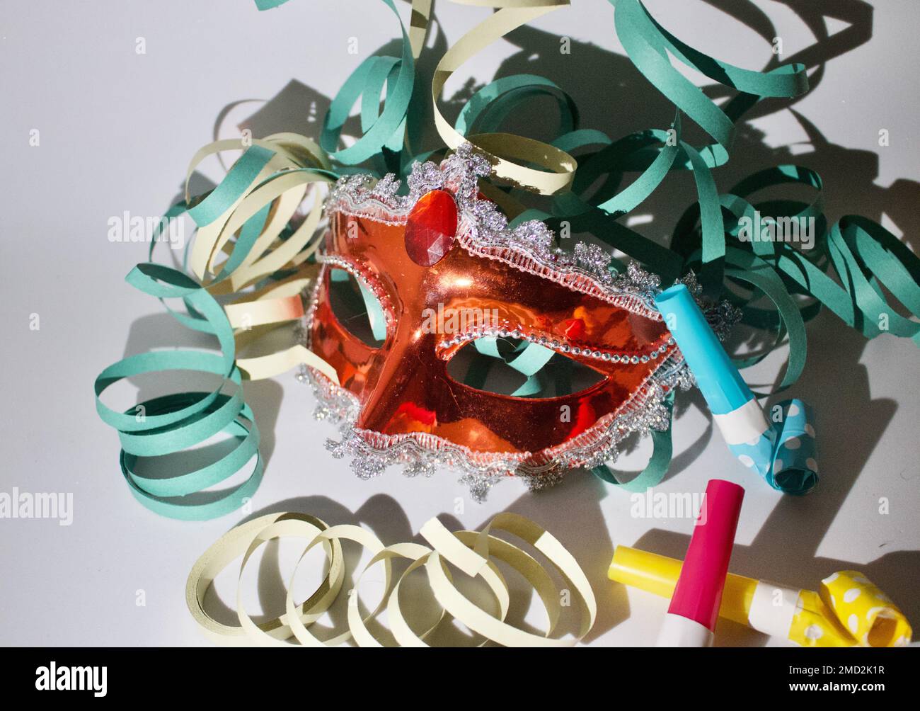 The red carnival mask with colorful paper streamers for party ...