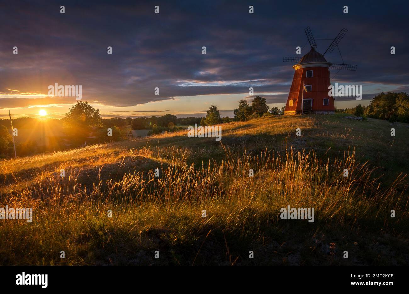 The traditional windmill in the field at sunset Stock Photo - Alamy