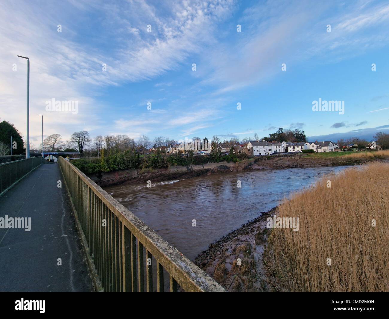 A view of a bridge over a river in the village Stock Photo - Alamy