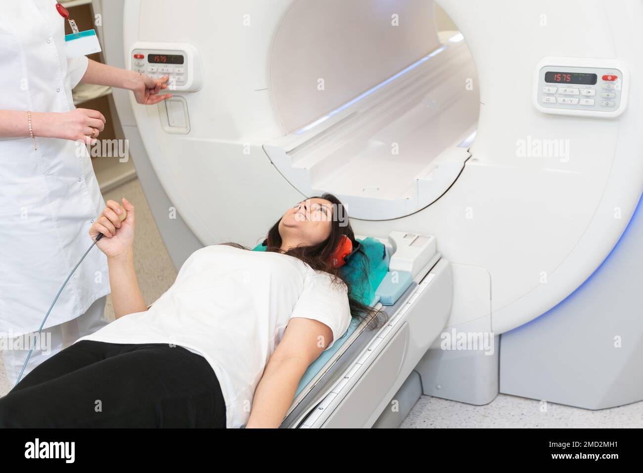 Female patient undergoing MRI - Magnetic resonance imaging in Hospital ...