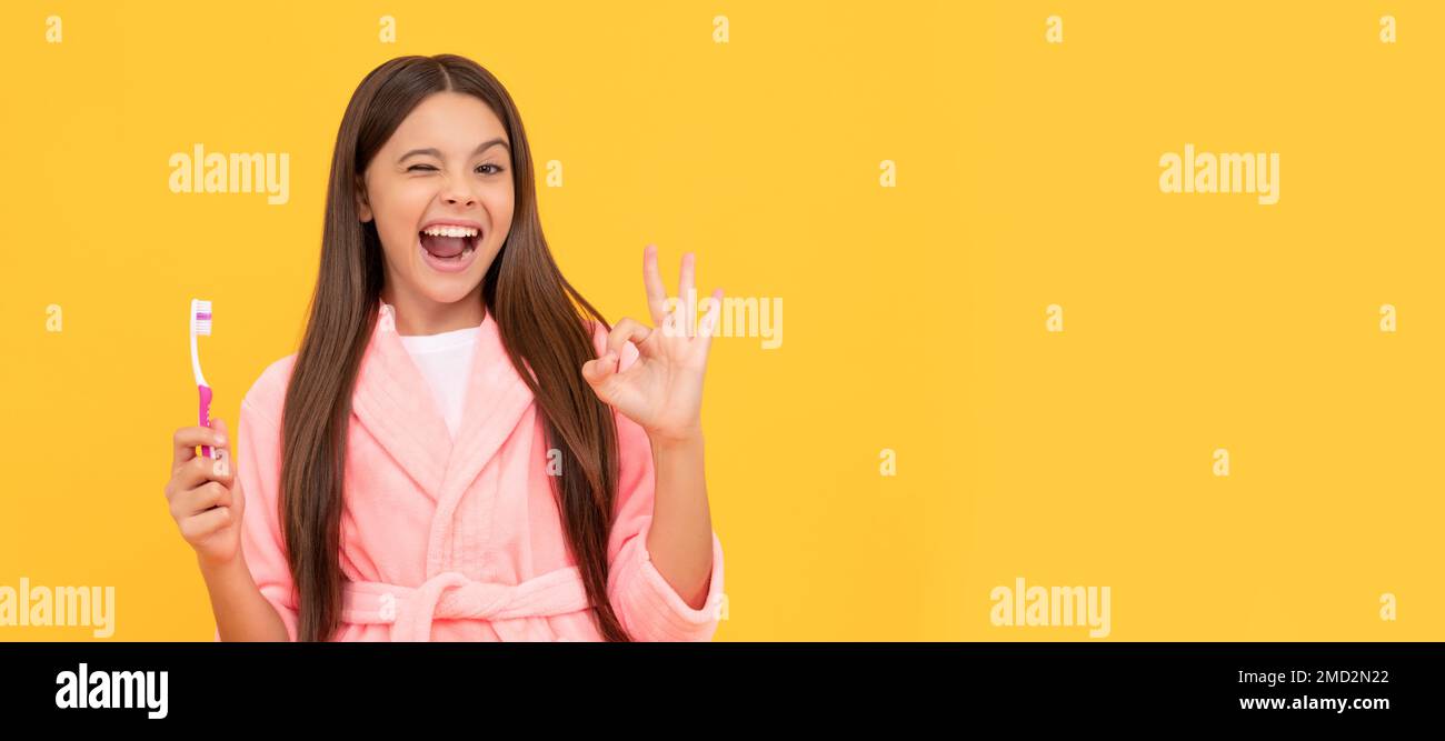 happy child girl in cozy bathrobe use toothbrush and hold apple, health ...