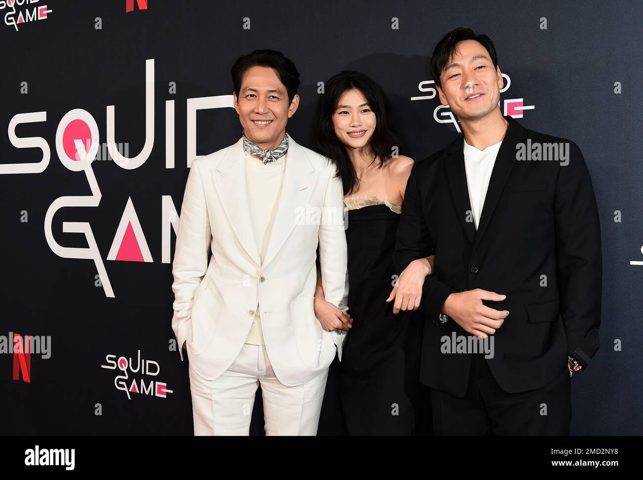 From left, cast members Lee Jung-jae, Jung Hoyeon and Park Hae Soo arrive at a red carpet event ...