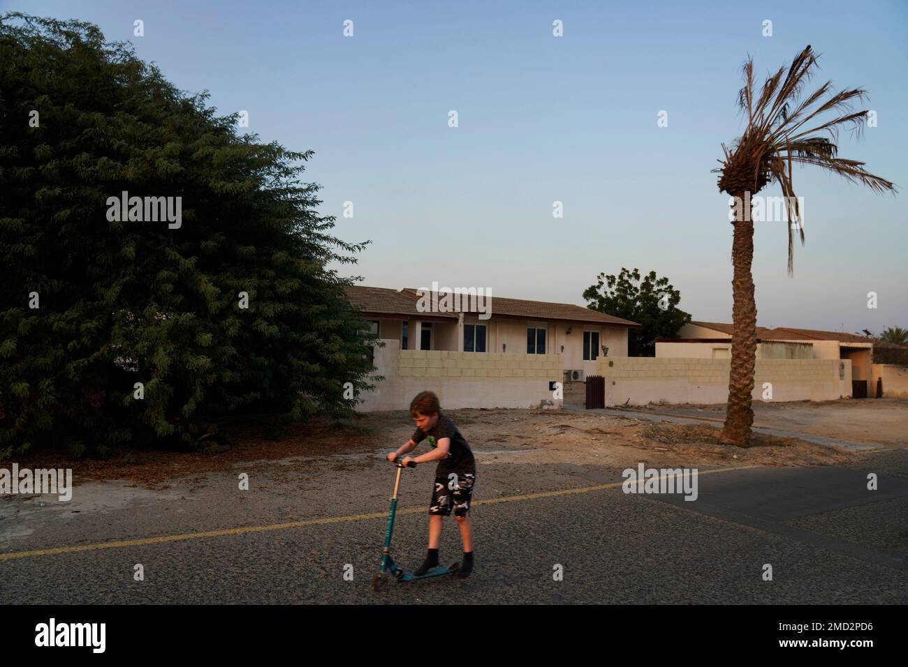 With an empty villa behind him, 7-year-old Elliot Dickinson rides his ...