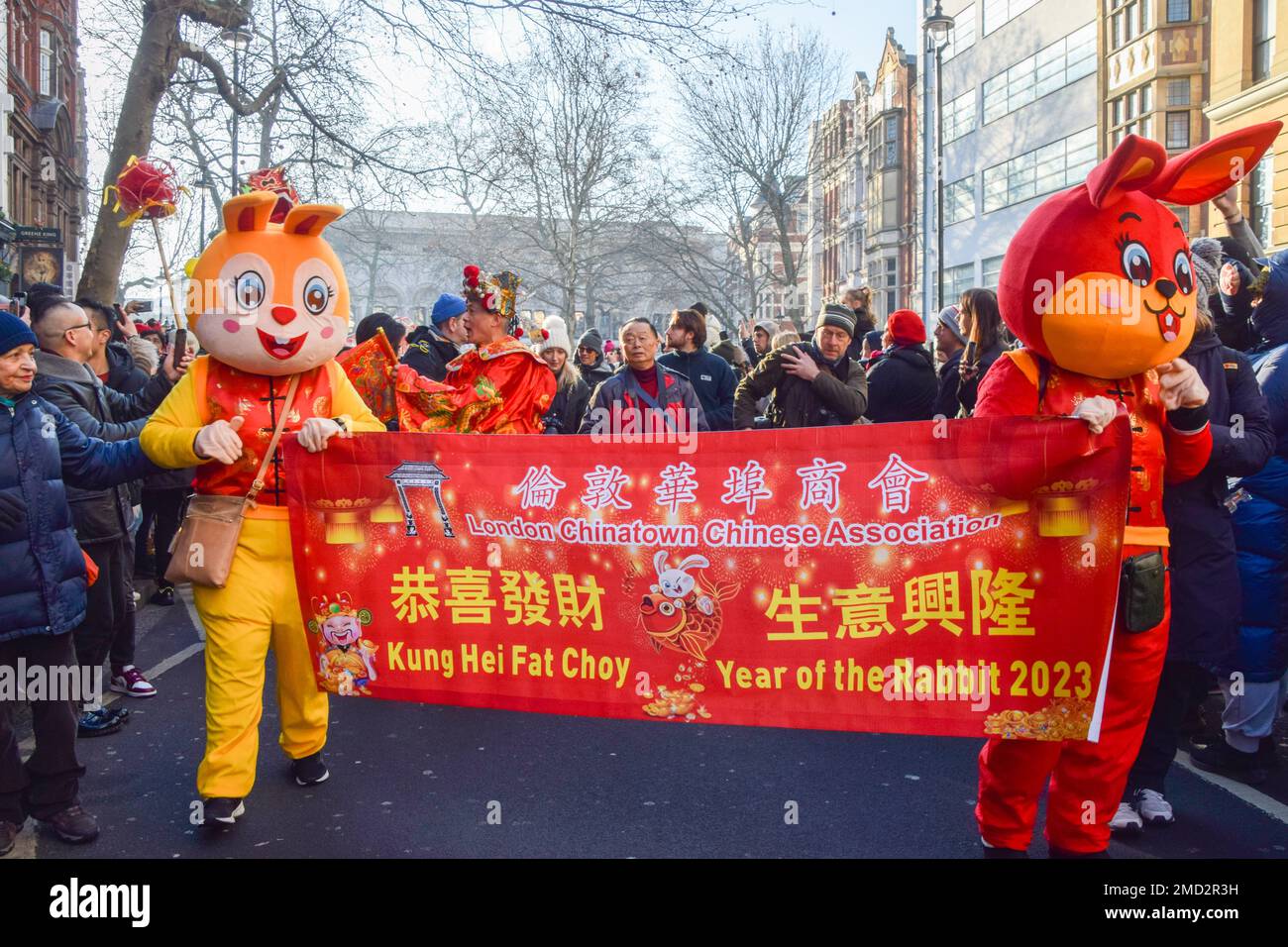 Participants wearing costumes hold a Year of the Rabbit banner at the ...
