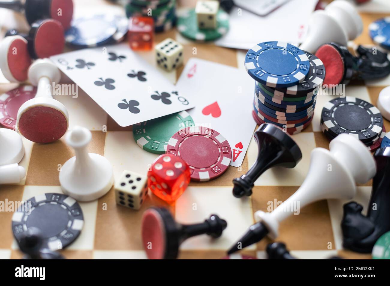Wooden checkers, chess pieces, playing cards, board games on a light ...