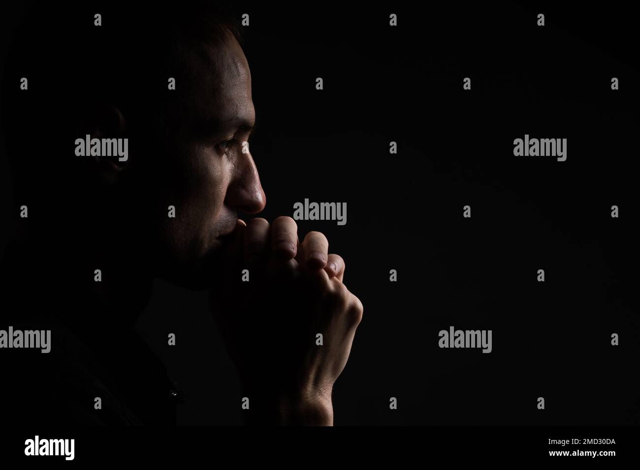 Portrait of a handsome man praying over gray background Stock Photo - Alamy