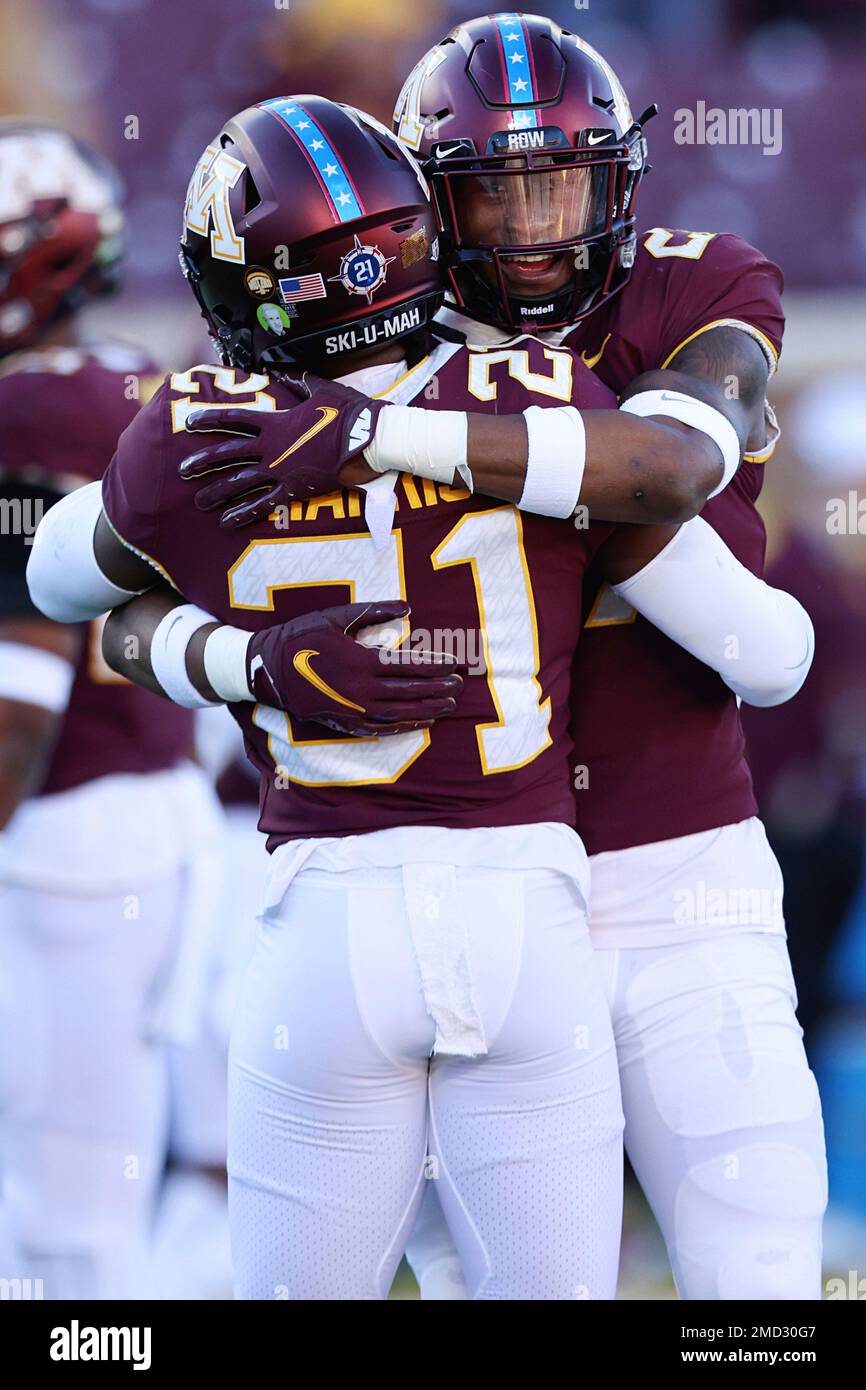 Minnesota defensive backs Tyler Nubin (27) and Justus Harris (21) greet ...