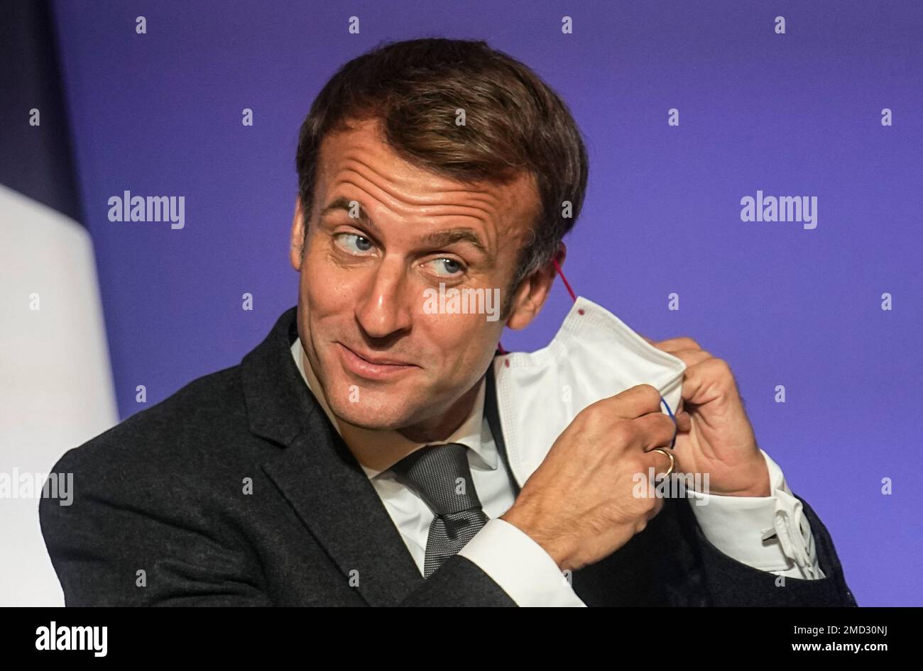 French President Emmanuel Macron, takes off his mask to protect against ...