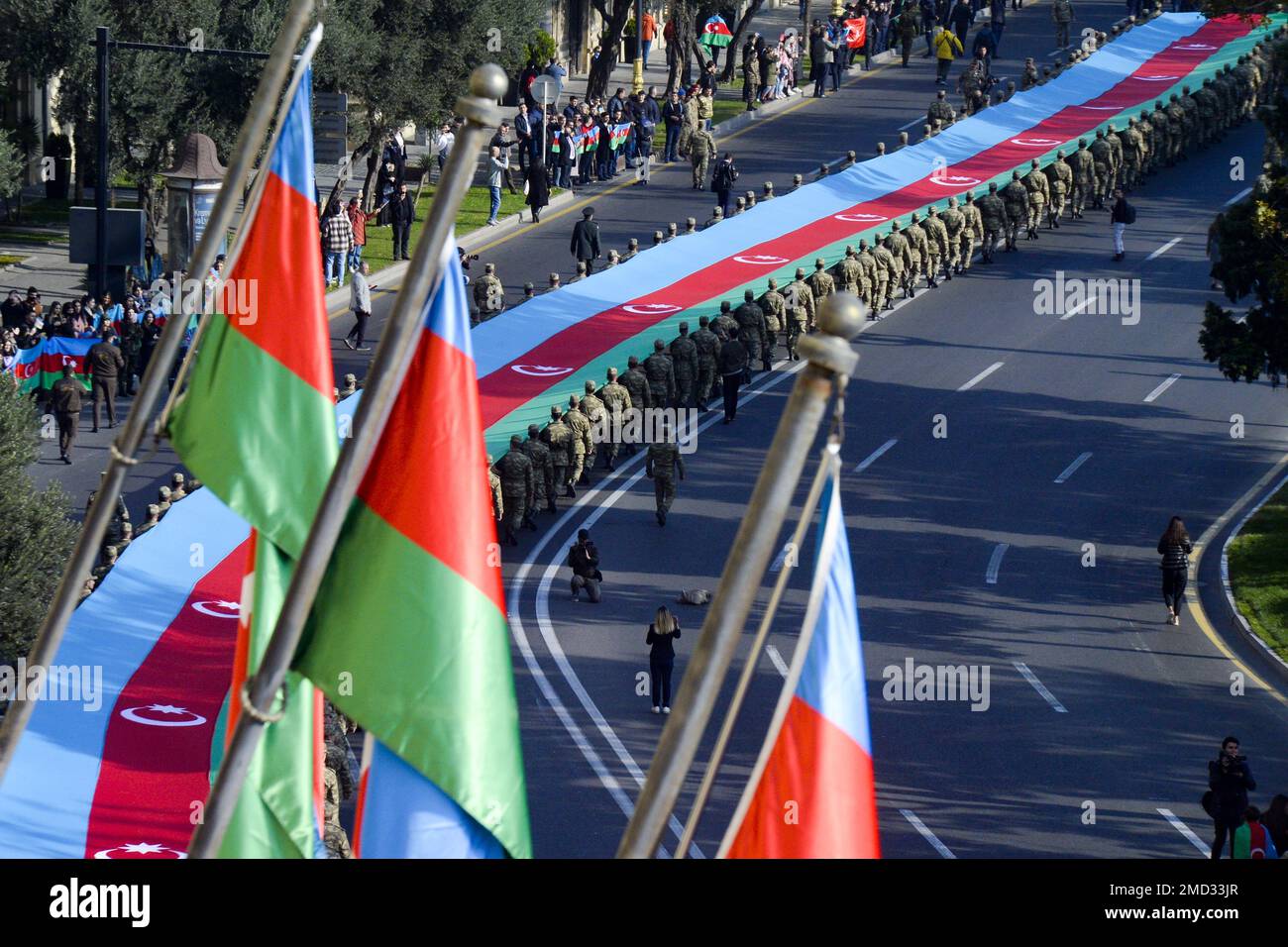 Soldiers carry a 440-meter-long (1,444-foot) Azerbaijan national flag ...