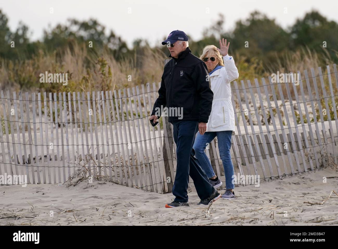 President Joe Biden and first lady Jill Biden walk along the beach in ...
