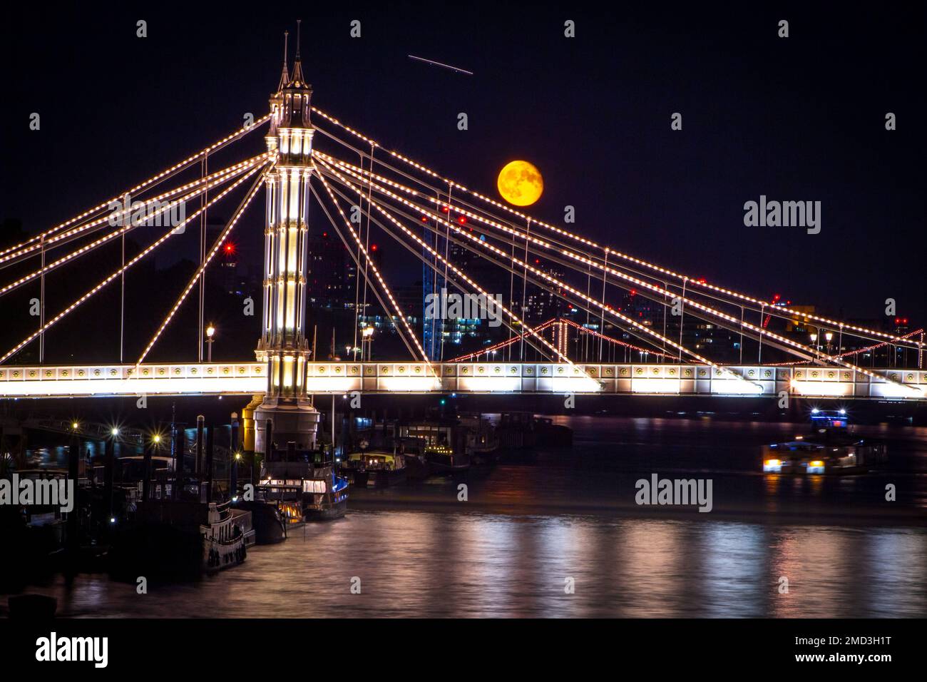 A beautiful shot of an illuminated bridge under the golden moon in ...