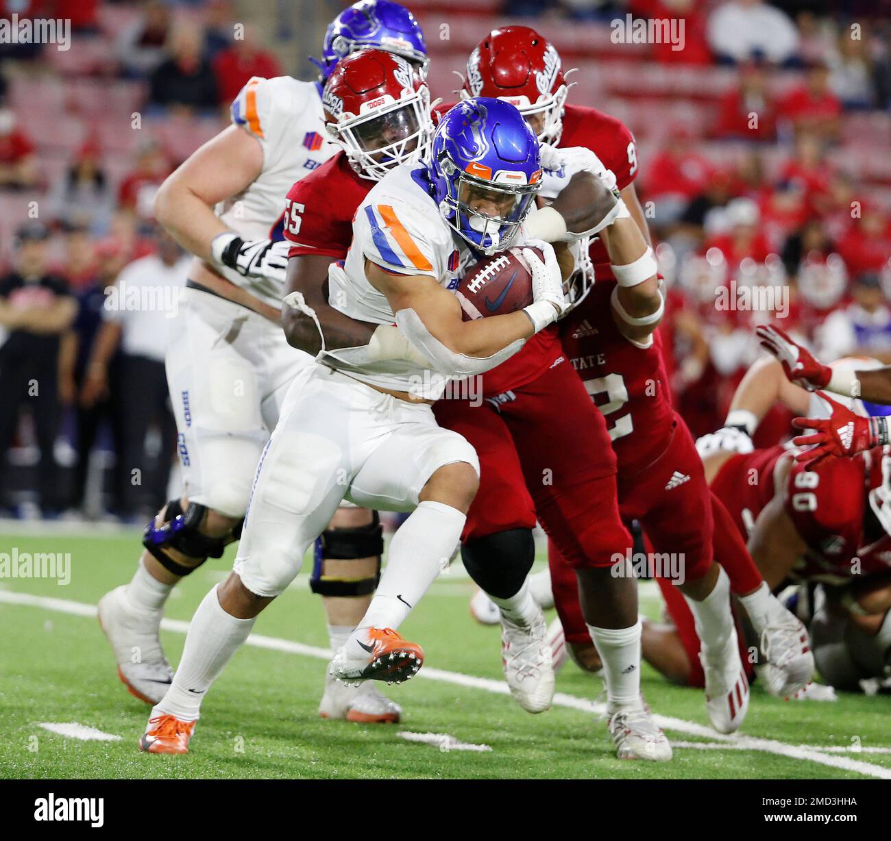 Boise State running back George Holani, front, runs by Fresno State ...