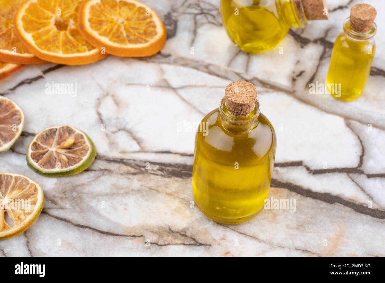 Lemon And Orange Oil Concept. Oil And Citrus Fruits On A Marble Floor ...