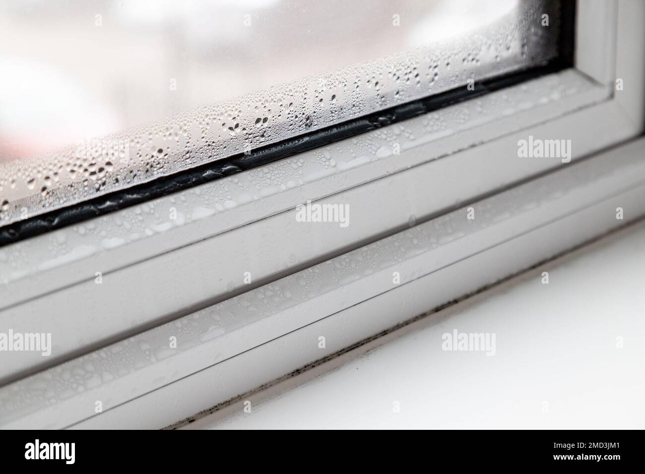 Closeup to condensation and water on the inside of modern upvc windows ...