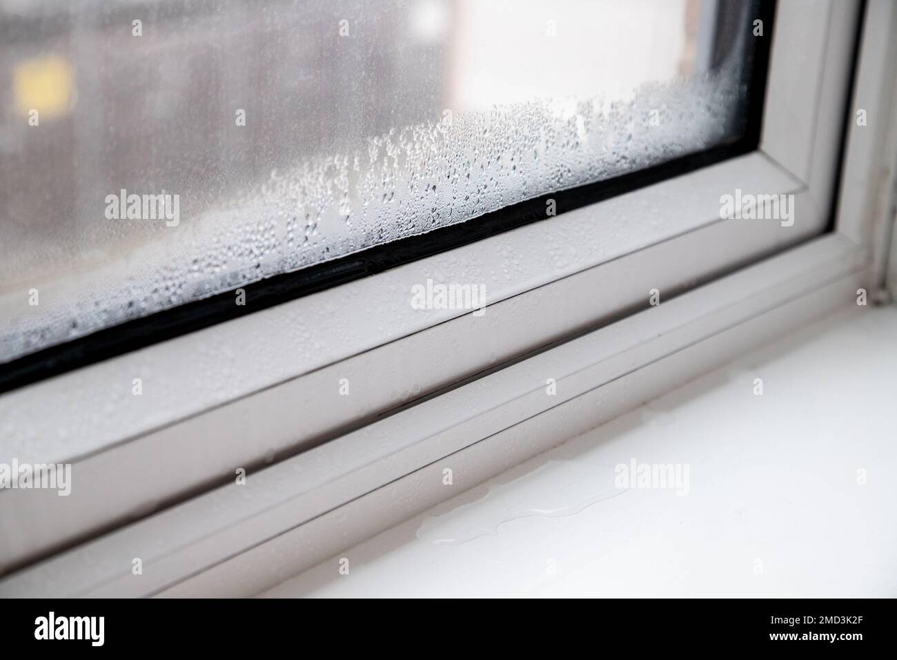 Closeup to condensation and water on the inside of modern upvc windows ...