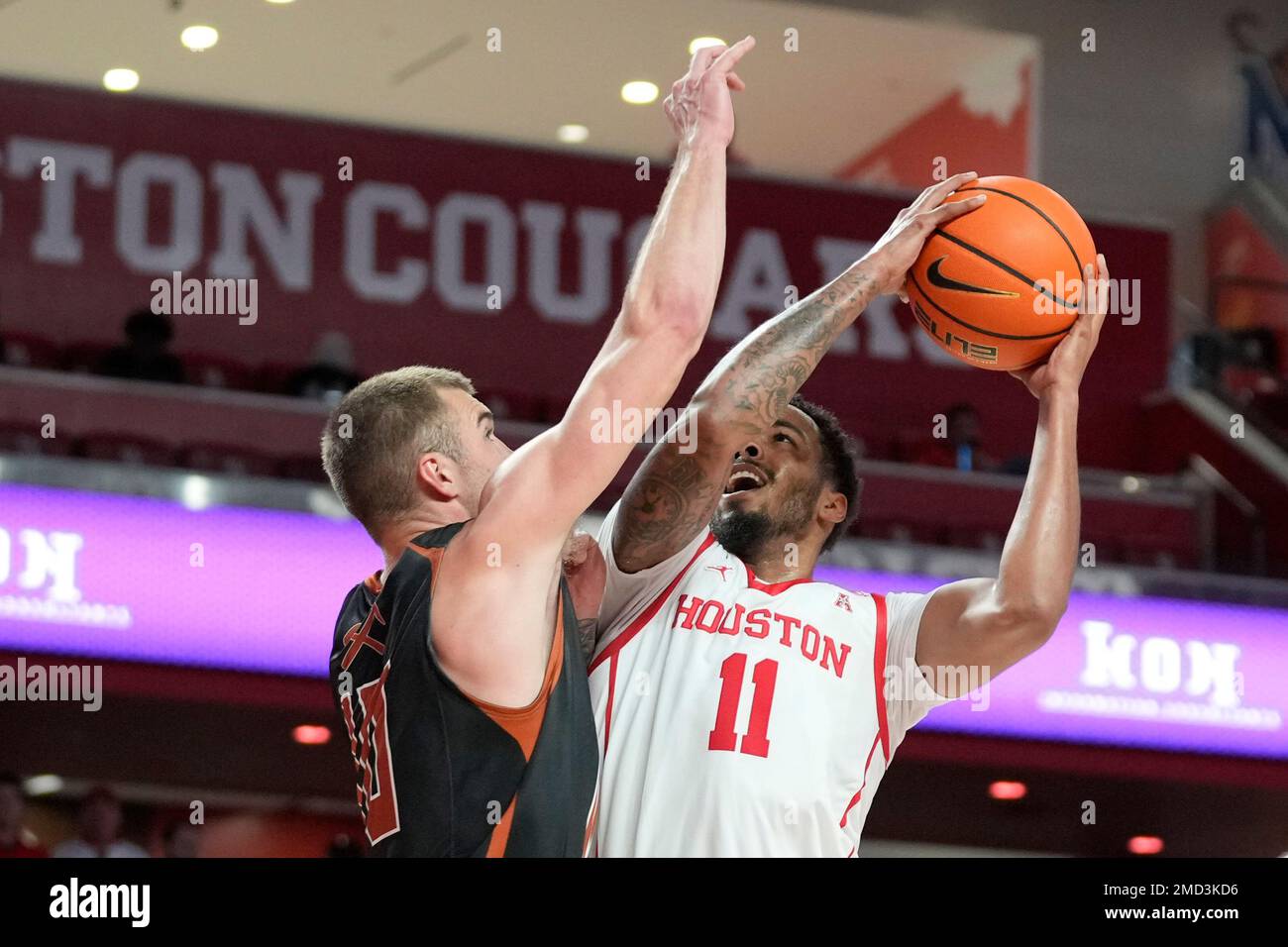 Houston guard Kyler Edwards (11) shoots as Montana Tech forward Caleb ...