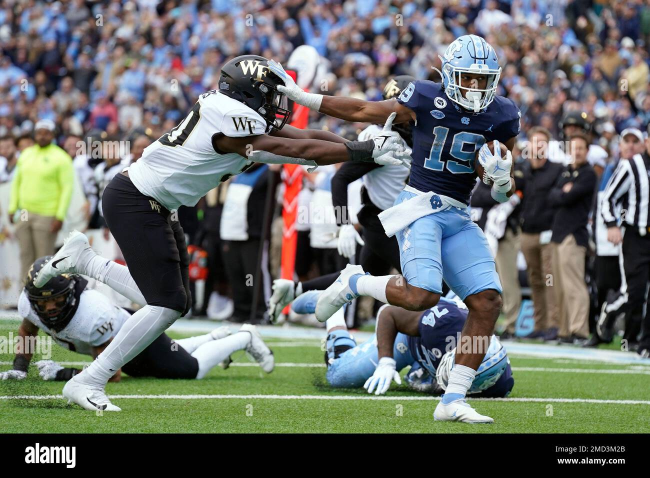 North Carolina running back Ty Chandler (19) runs for a tochdown while Wake Forest defensive ...