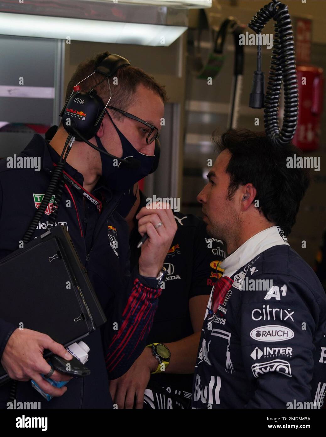 Red Bull driver Sergio Perez, of Mexico, right, talks to a member of ...