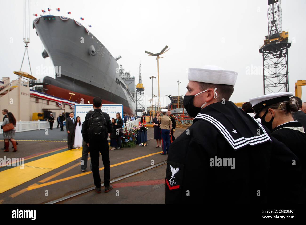 U.S. Navy shipman Aaron Henderson looks over at the USNS Harvey Milk, a ...