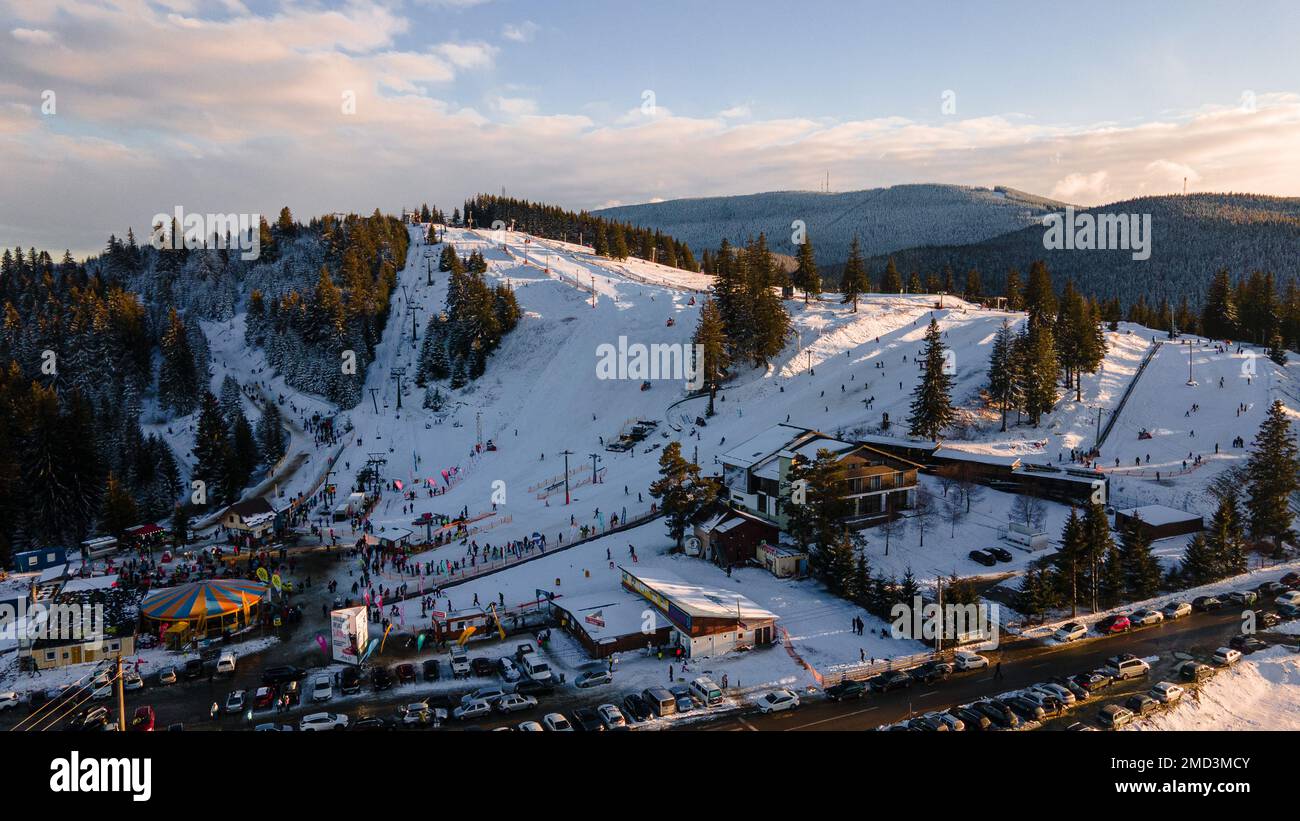 Aerial view of a skying slope on top of the mountain in winter season ...