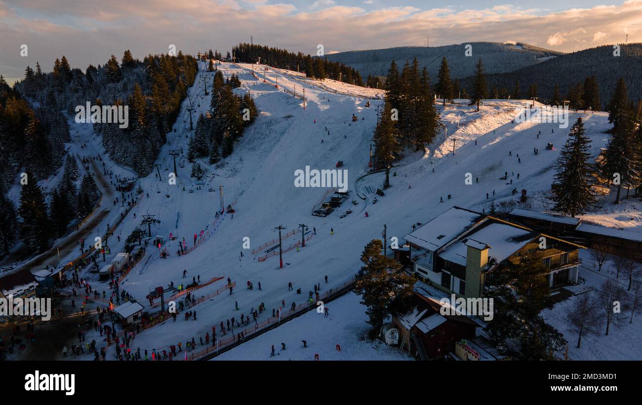 Aerial view of a skying slope on top of the mountain in winter season ...