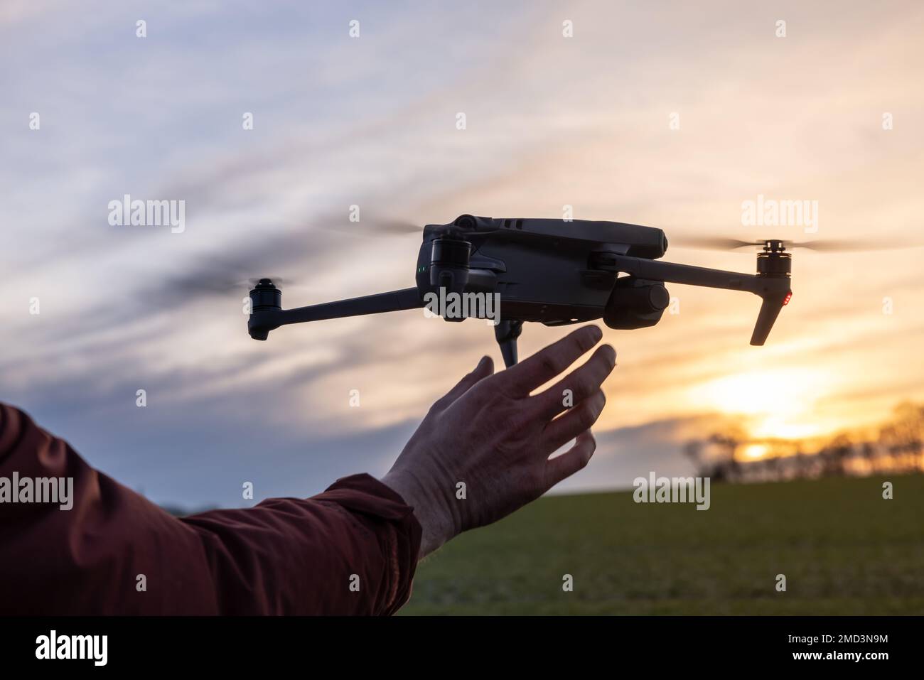 Drone Pilot Launching Drone from Hand at Sunset Stock Photo - Alamy