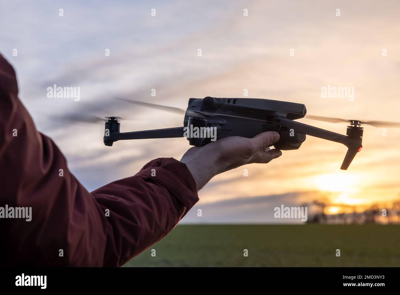 Drone Pilot Launching Drone from Hand at Sunset Stock Photo - Alamy