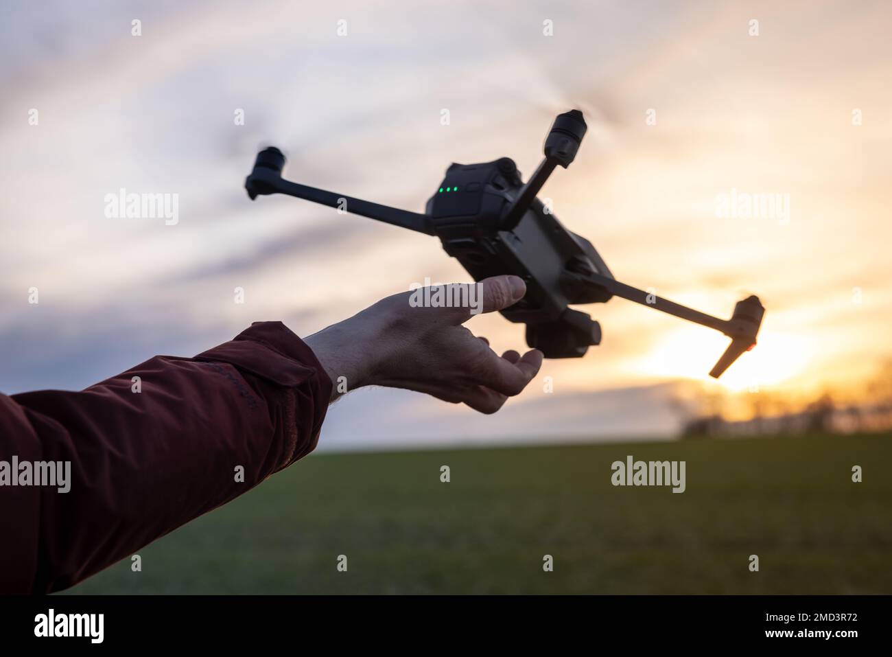 Drone Pilot Launching Drone from Hand at Sunset Stock Photo - Alamy