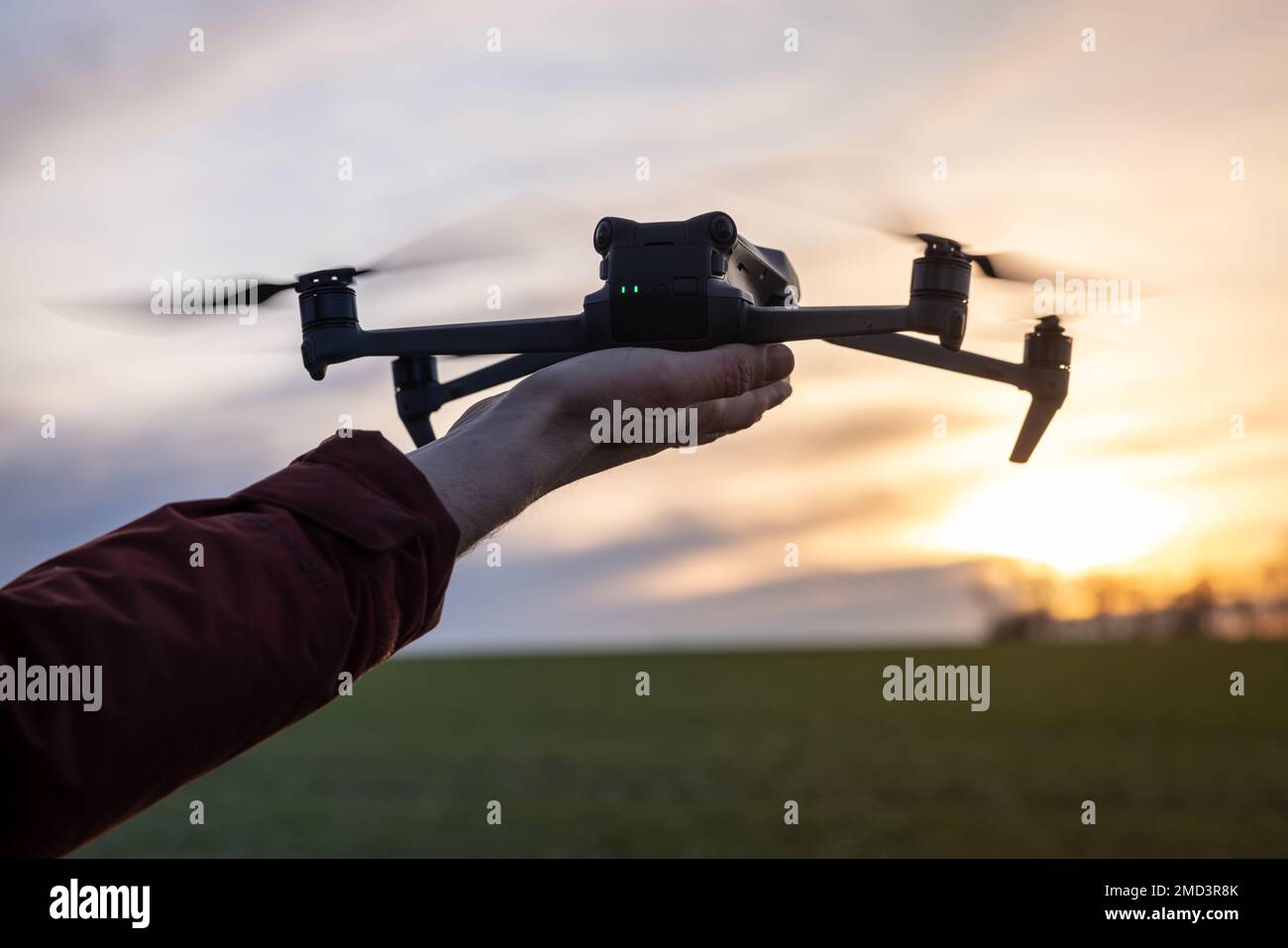 Drone Pilot Launching Drone from Hand at Sunset Stock Photo - Alamy