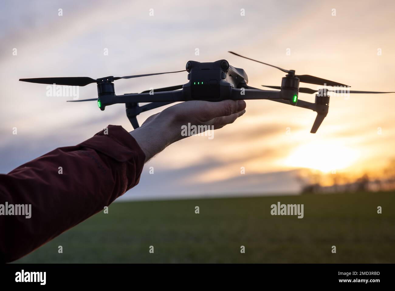 Drone Pilot Launching Drone from Hand at Sunset Stock Photo - Alamy