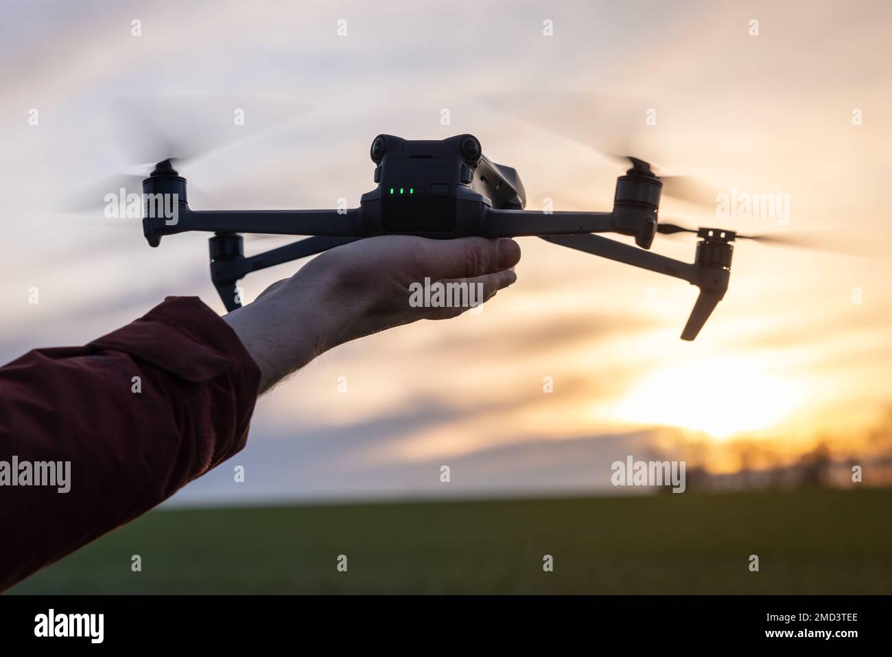 Drone Pilot Launching Drone from Hand at Sunset Stock Photo - Alamy