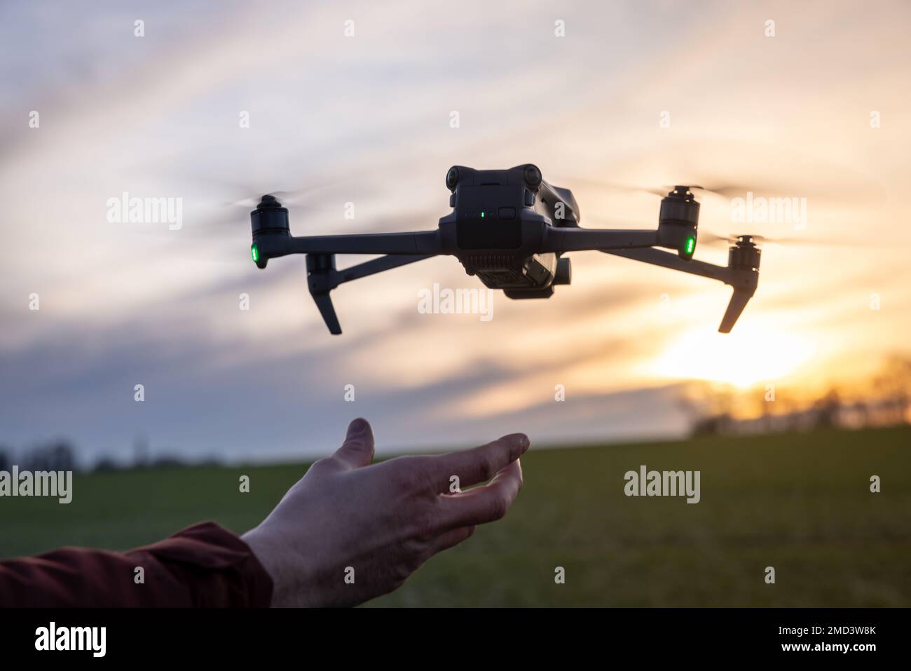 Drone Pilot Launching Drone from Hand at Sunset Stock Photo - Alamy