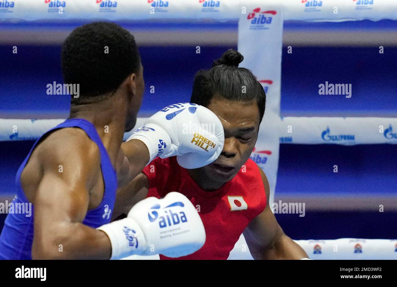 United States' Omari Jones, left, fights with Japan's Sewonrets Okazawa ...