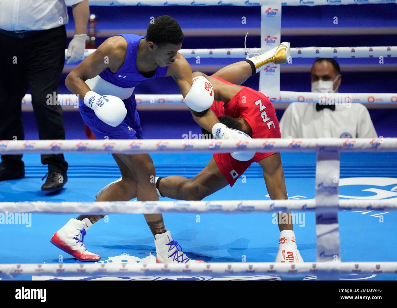 United States' Omari Jones, left, fights with Japan's Sewonrets Okazawa ...