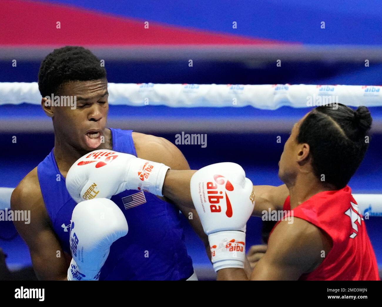 United States' Omari Jones, left, fights with Japan's Sewonrets Okazawa ...